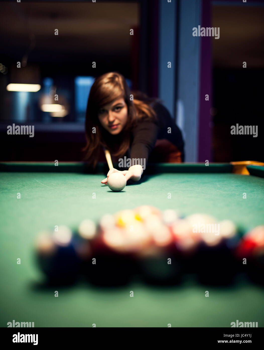 Young woman playing billiard Stock Photo - Alamy