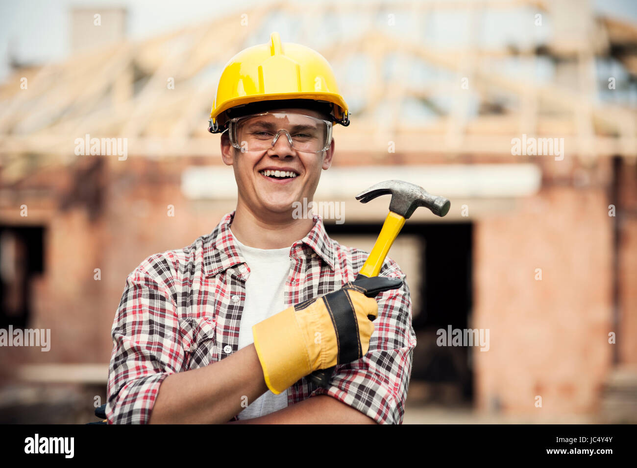 Construction worker with hammer Stock Photo - Alamy