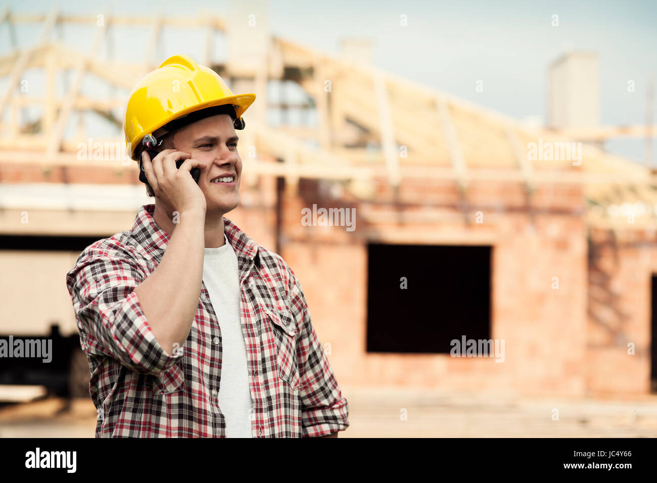 Construction worker with mobile phone Stock Photo - Alamy