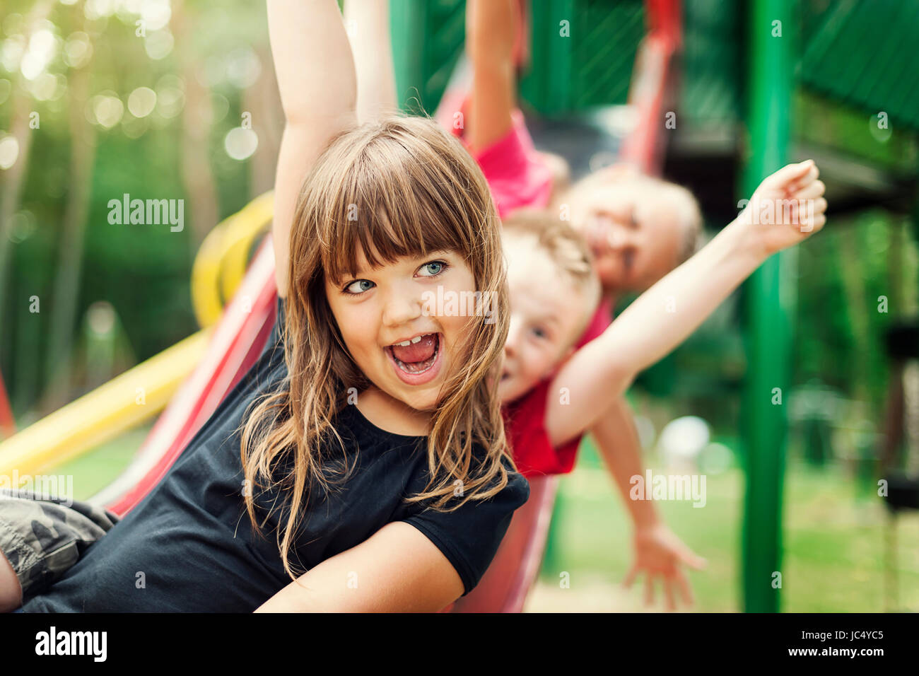 Kids having fun on slide Stock Photo - Alamy