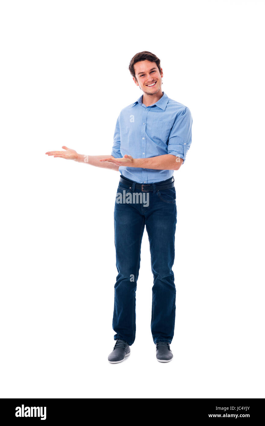Smiling young man presenting something Stock Photo - Alamy