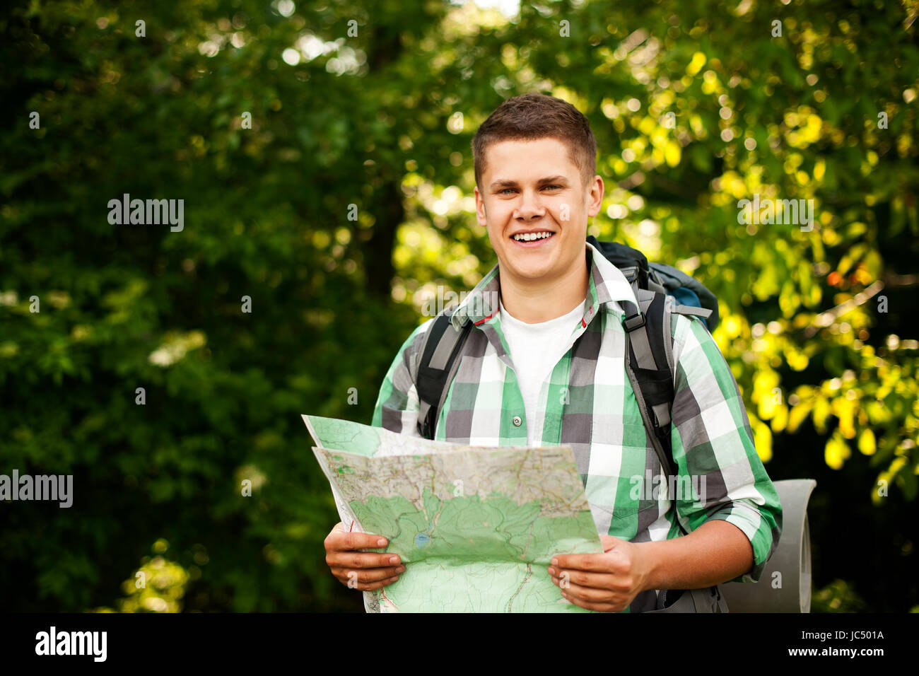 Man holding a map in forest Stock Photo - Alamy
