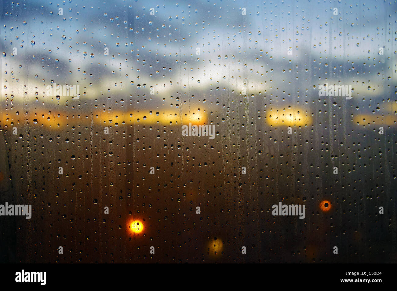 Raindrops on a window at sunset Stock Photo - Alamy