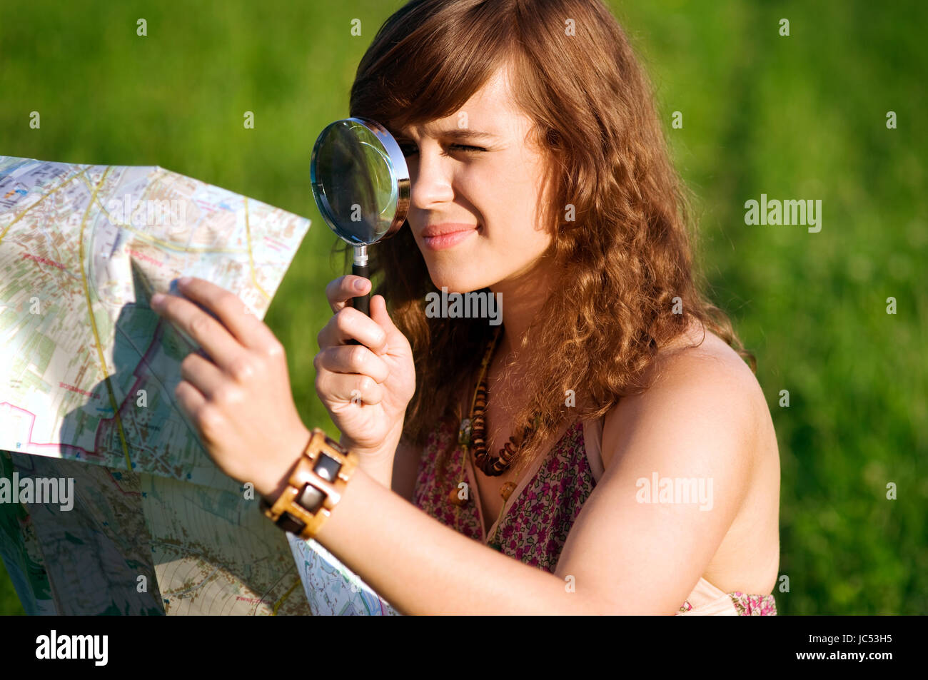 Beauty woman looking through magnifying glass Stock Photo - Alamy