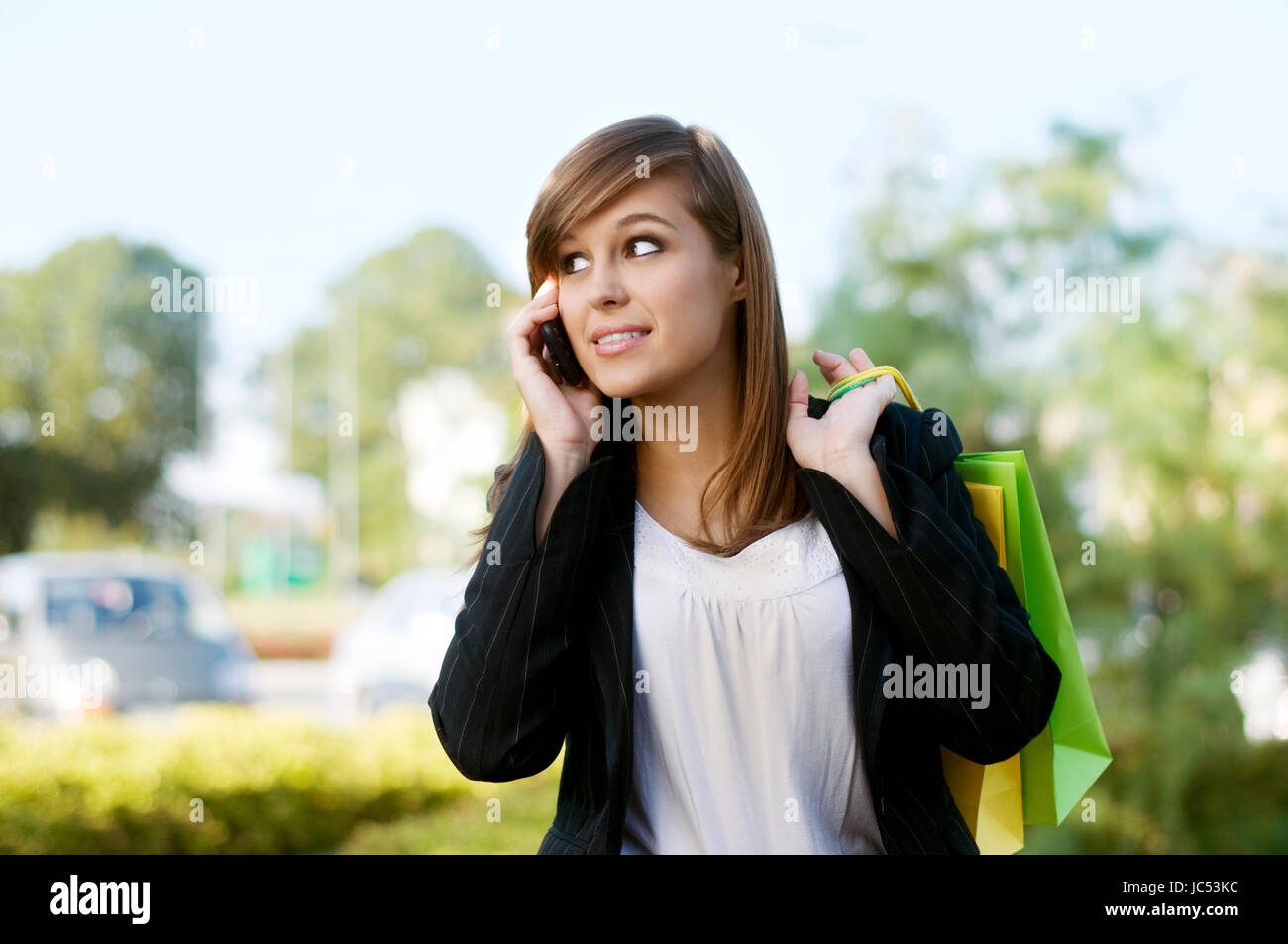 Young woman talking on the phone after shopping Stock Photo - Alamy