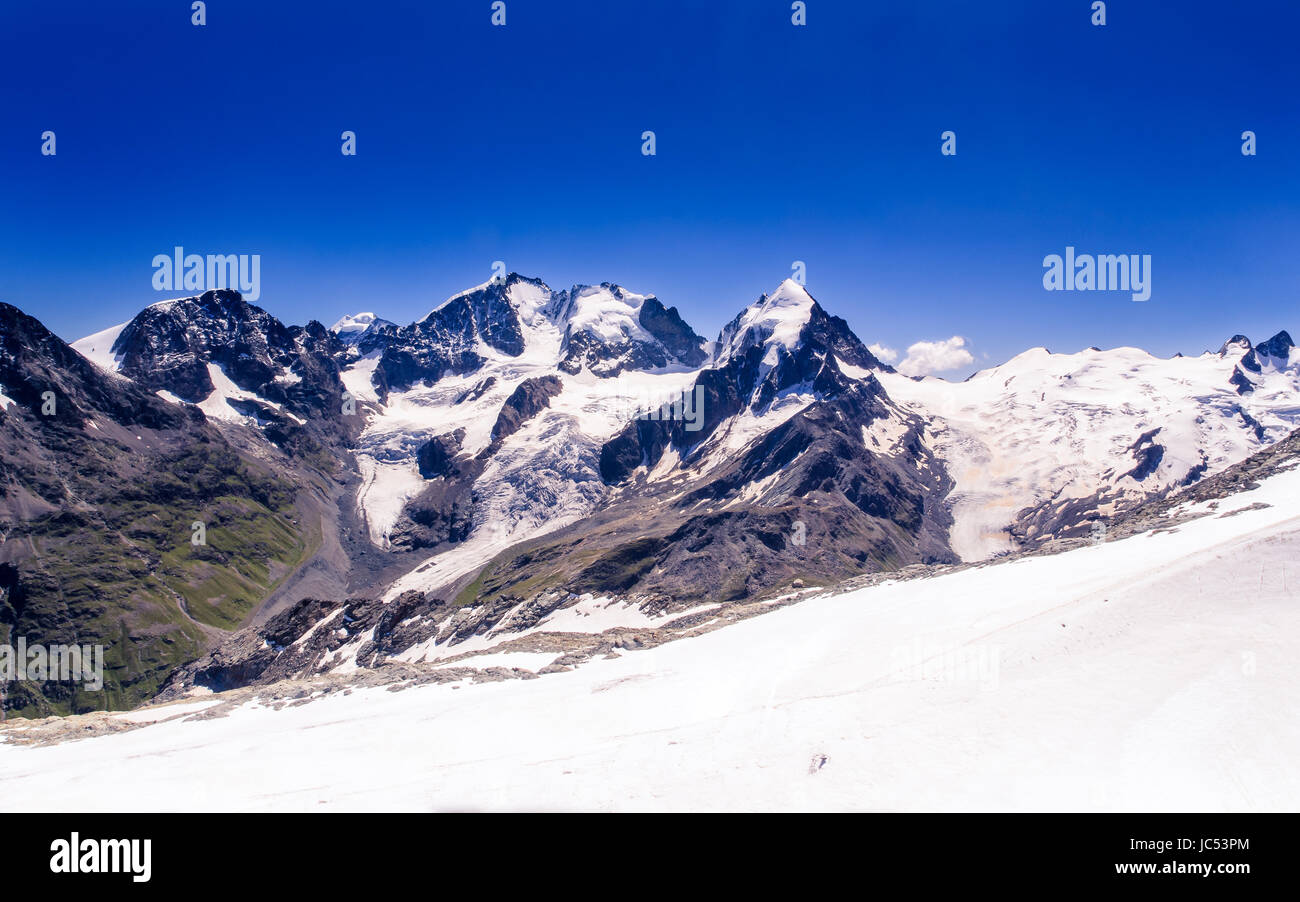 Snowy peaks of the Bernina range mountain tops under a clear blue sky ...