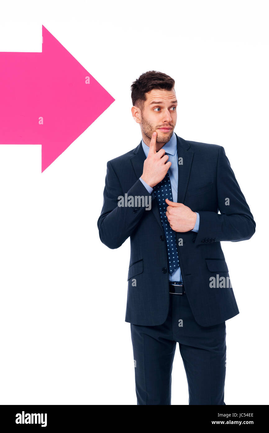Handsome businessman looking in the direction in which the arrow ...