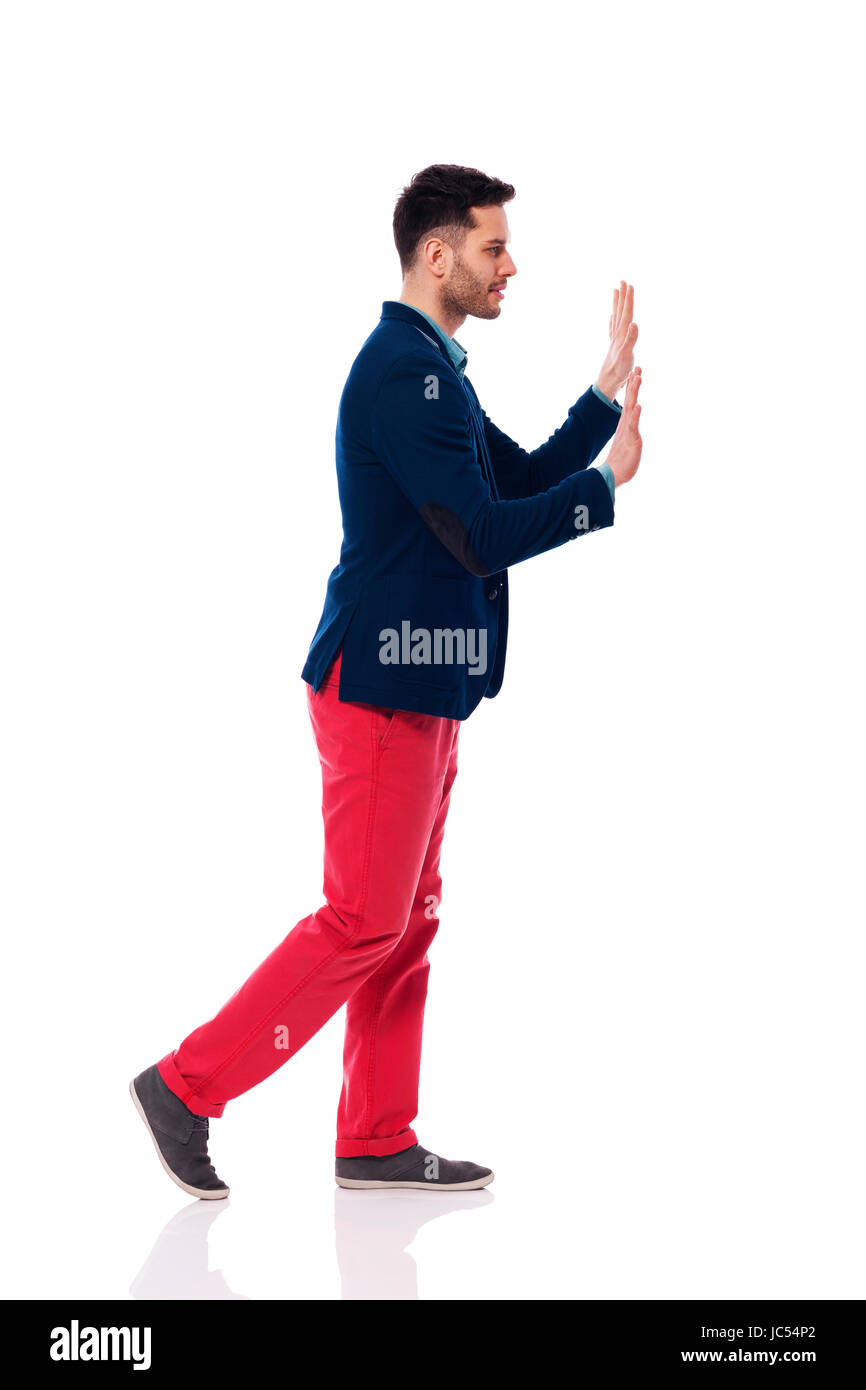 Fashionable young man pushing something Stock Photo - Alamy