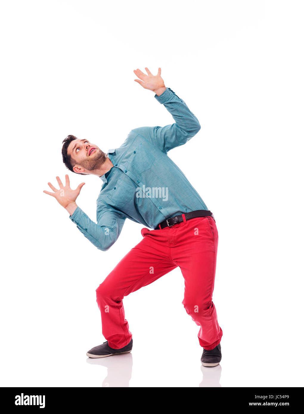 Young man bending under the weight of something Stock Photo - Alamy