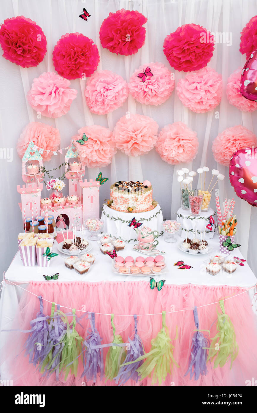 colorful birthday party table with cake Stock Photo - Alamy