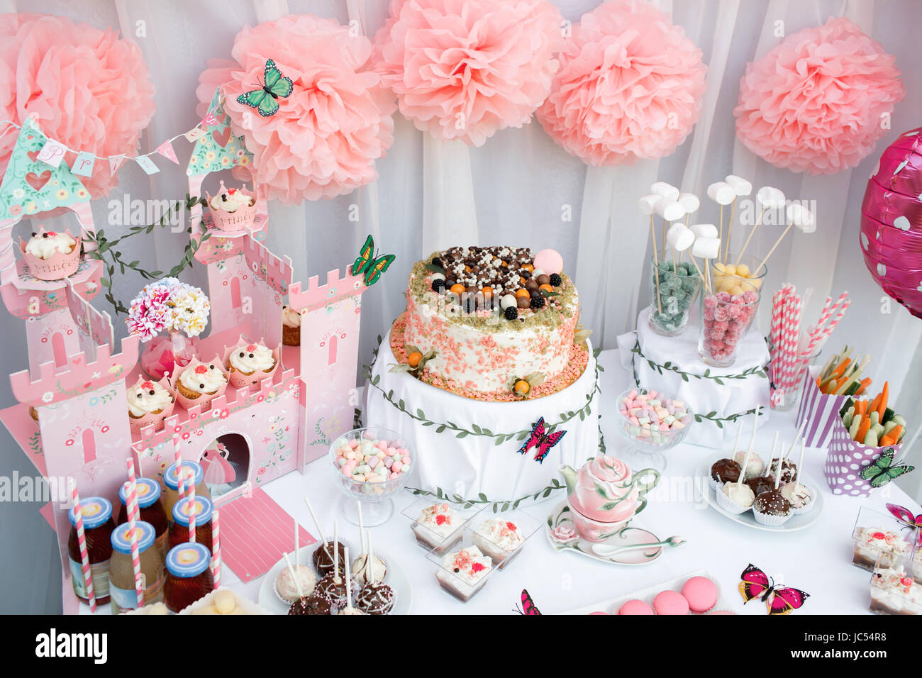 colorful birthday party table with cake Stock Photo - Alamy