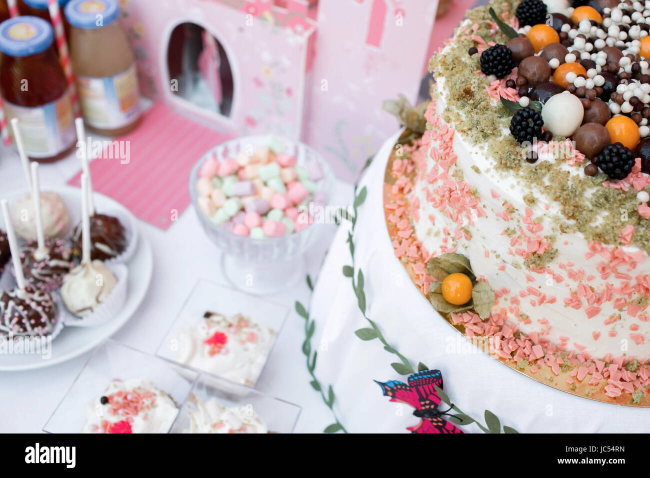 colorful birthday party table with cake Stock Photo - Alamy
