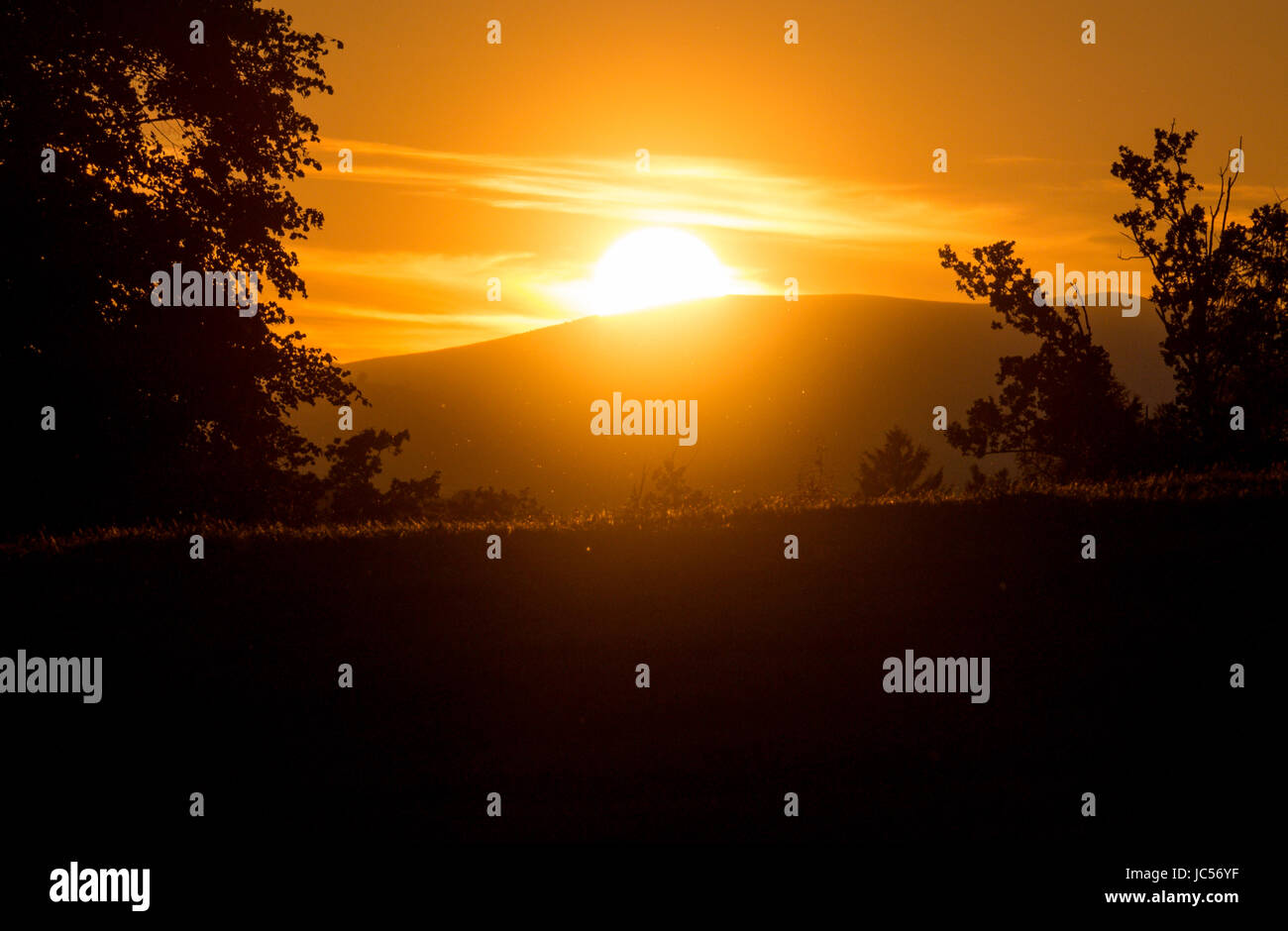 The sun setting behind the hills of southern Styria Stock Photo - Alamy