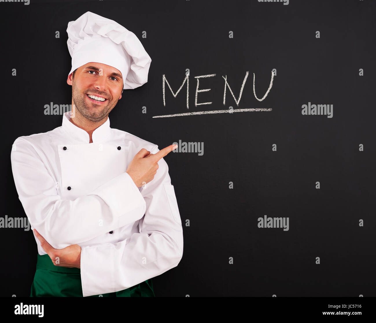 Handsome chef showing menu Stock Photo - Alamy