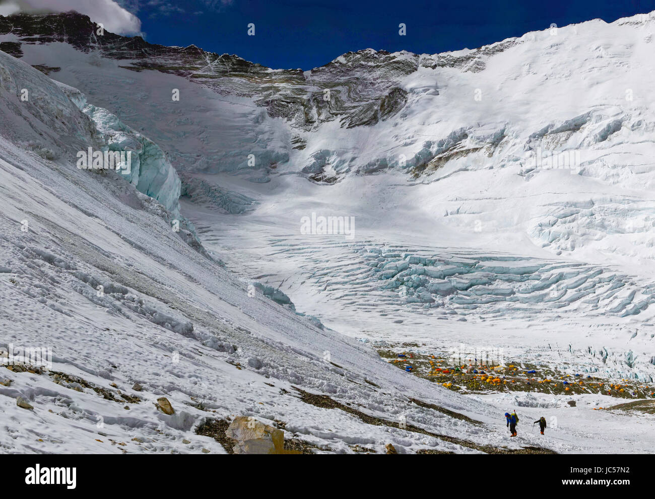 Climbers make their way up toward the West Ridge Headwall from Camp 2 ...