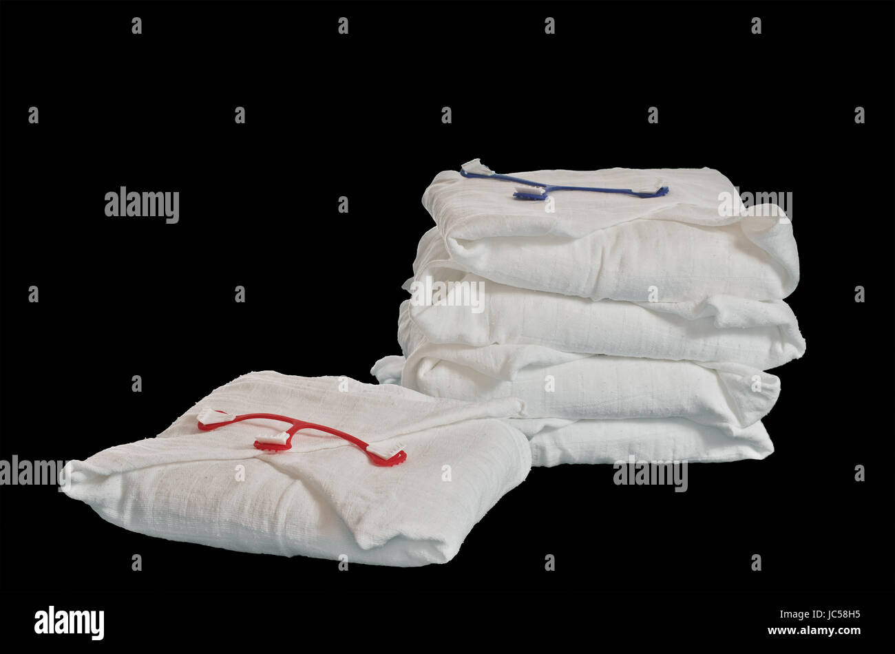 Isolated stacks of classical square white cloth diapers on black ...