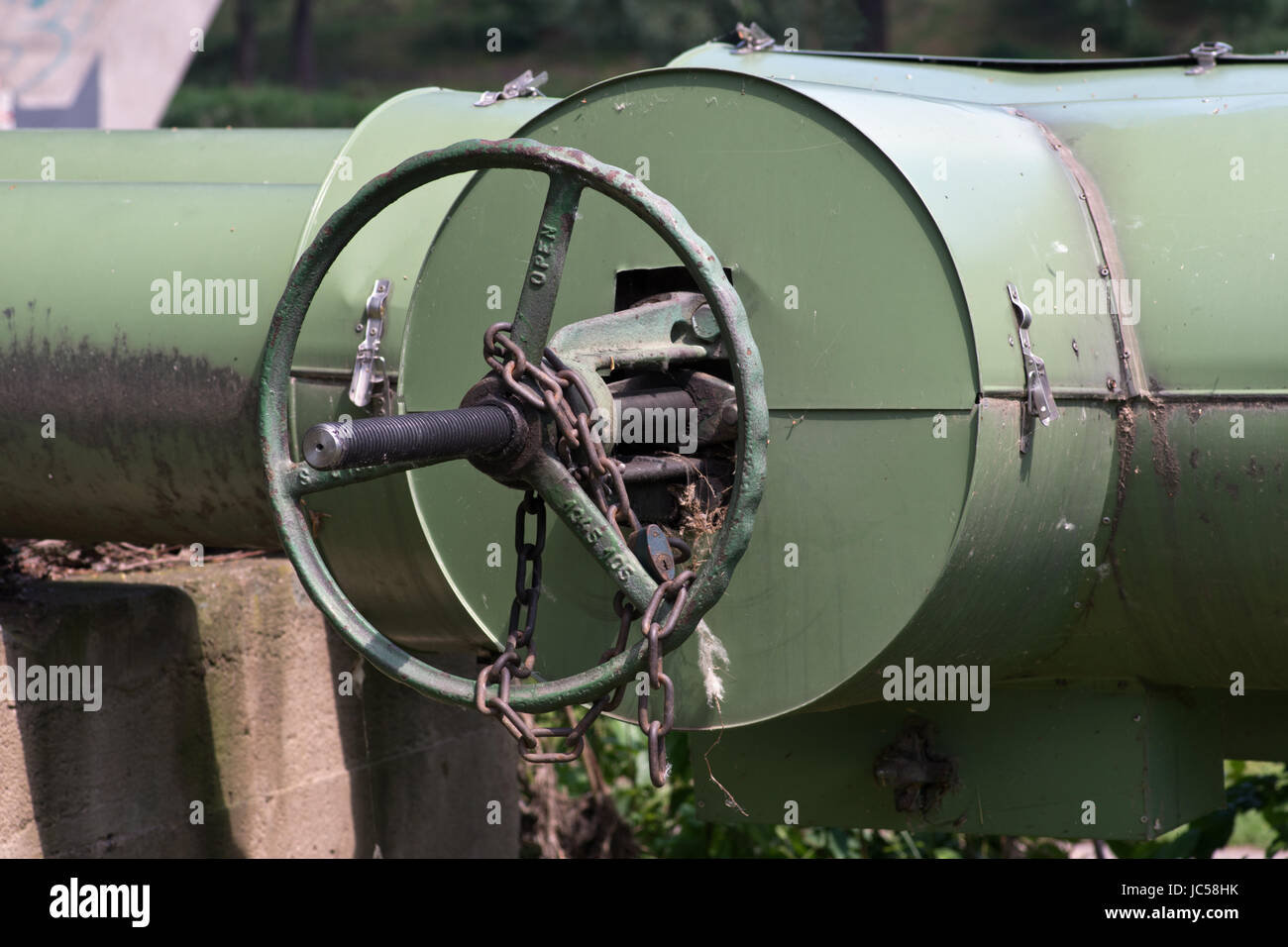 Photo of heat pipeline valve wheel with chain and lock Stock Photo - Alamy