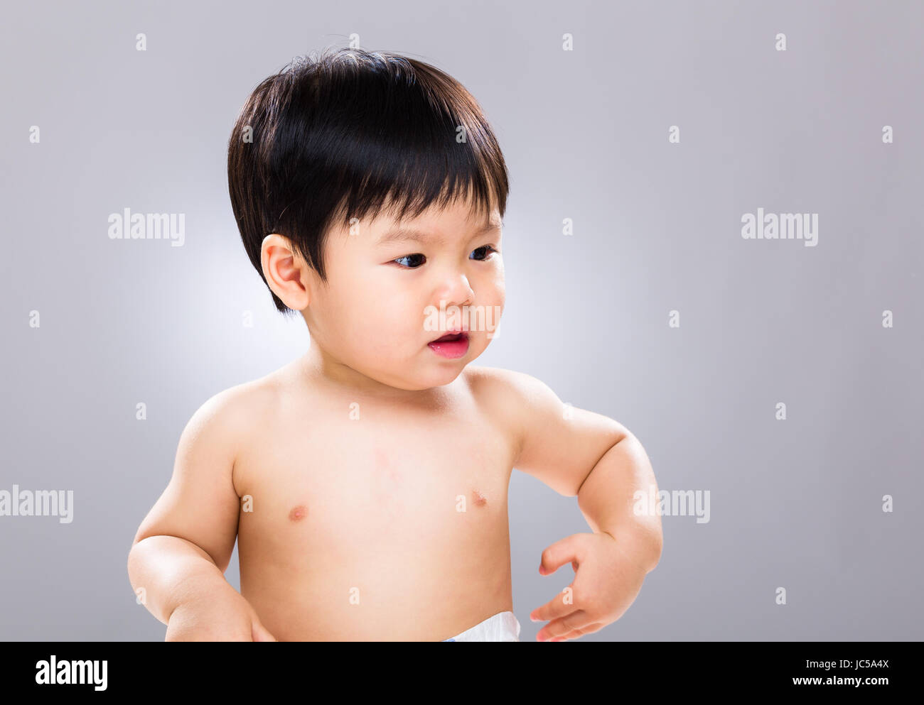 Baby boy scratch his body Stock Photo - Alamy