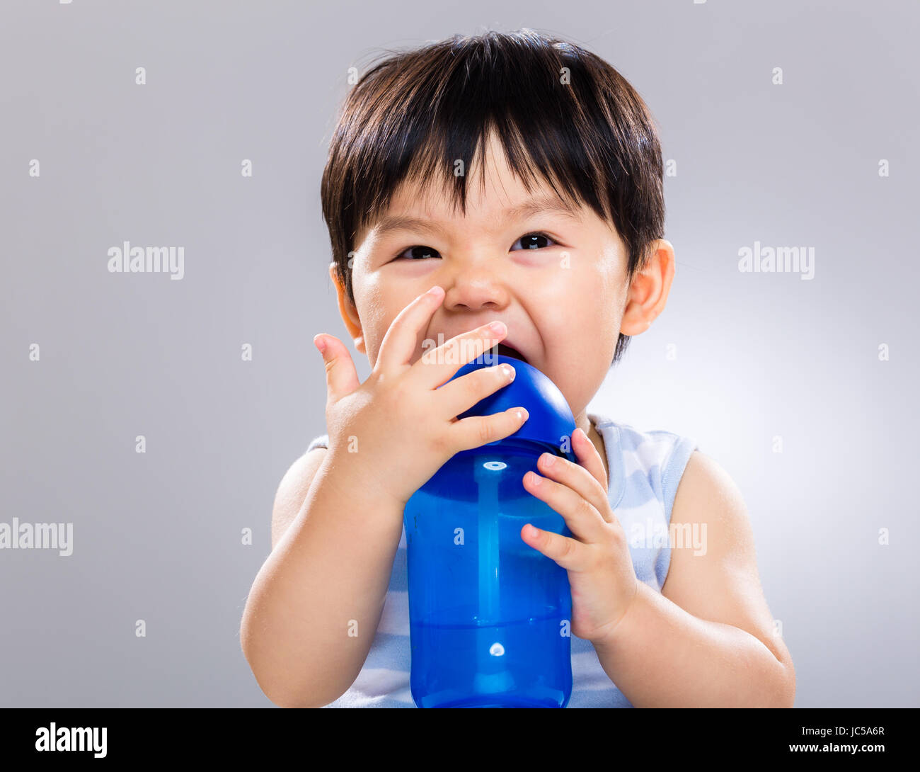 Happy baby boy drink with water bottle Stock Photo - Alamy