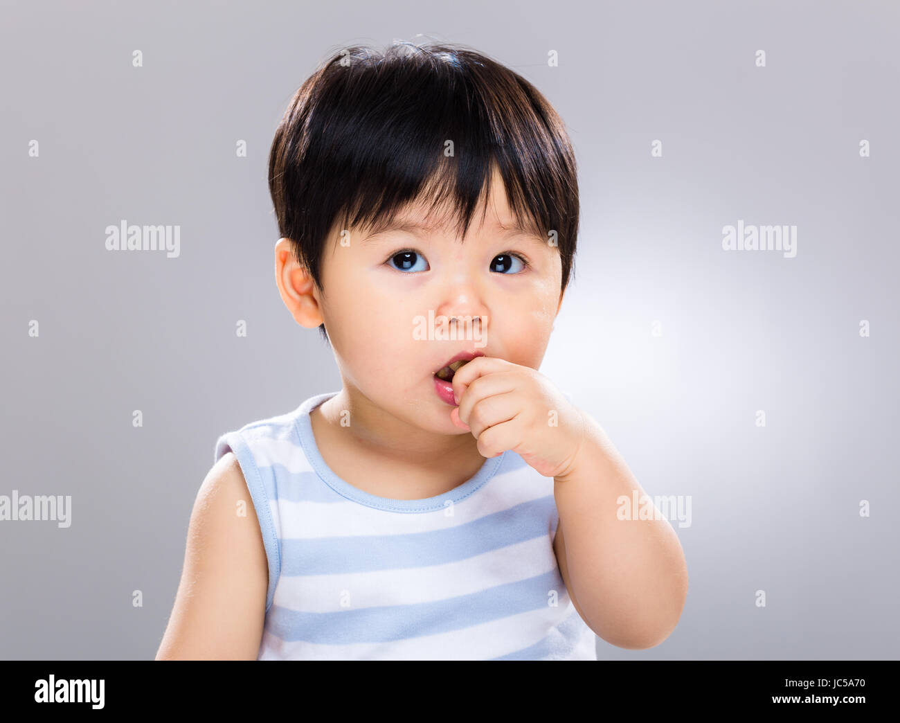 Baby boy eat finger food Stock Photo - Alamy