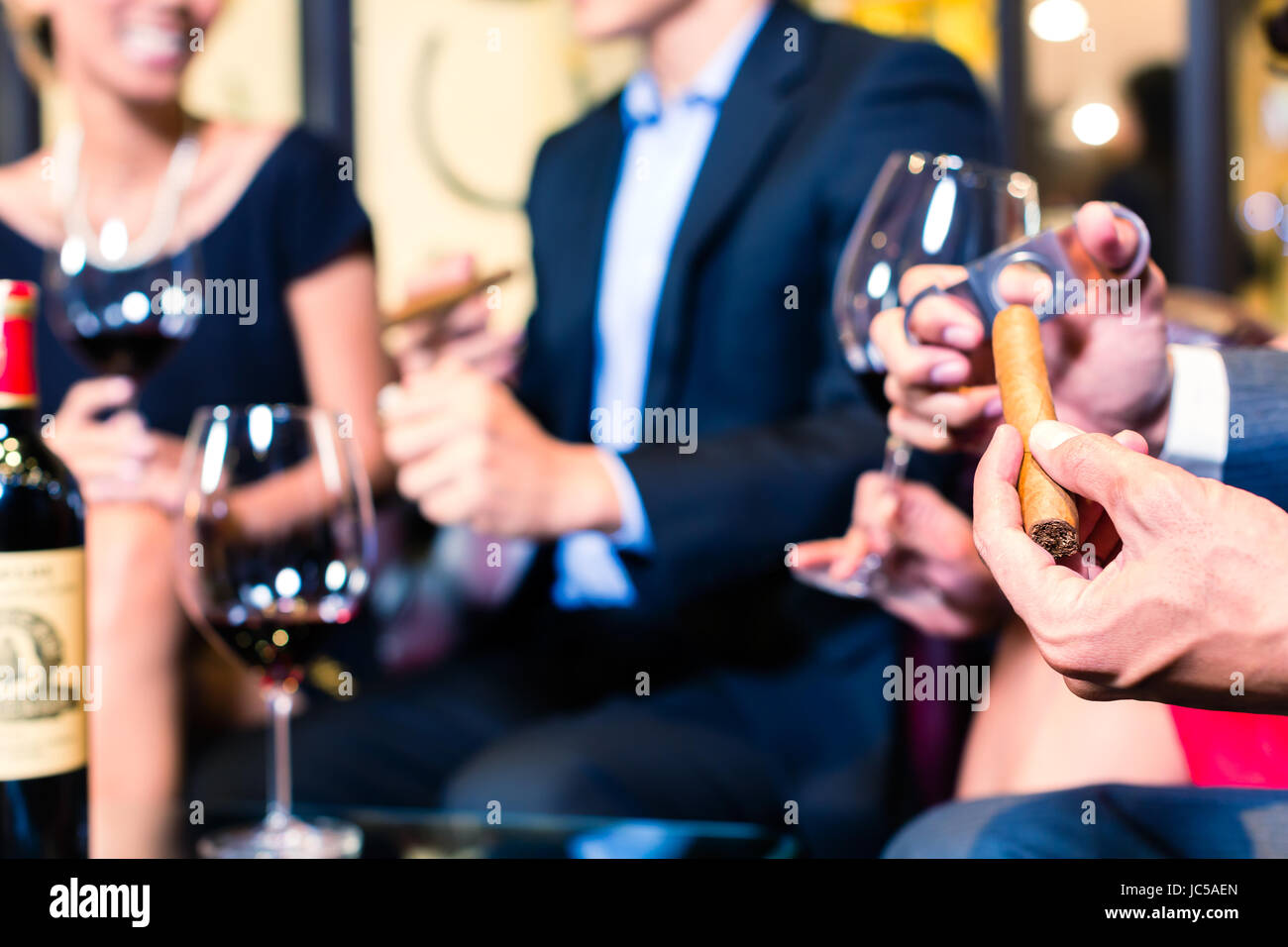Close up of Asian man's hand cutting cigar in restaurant Stock Photo ...
