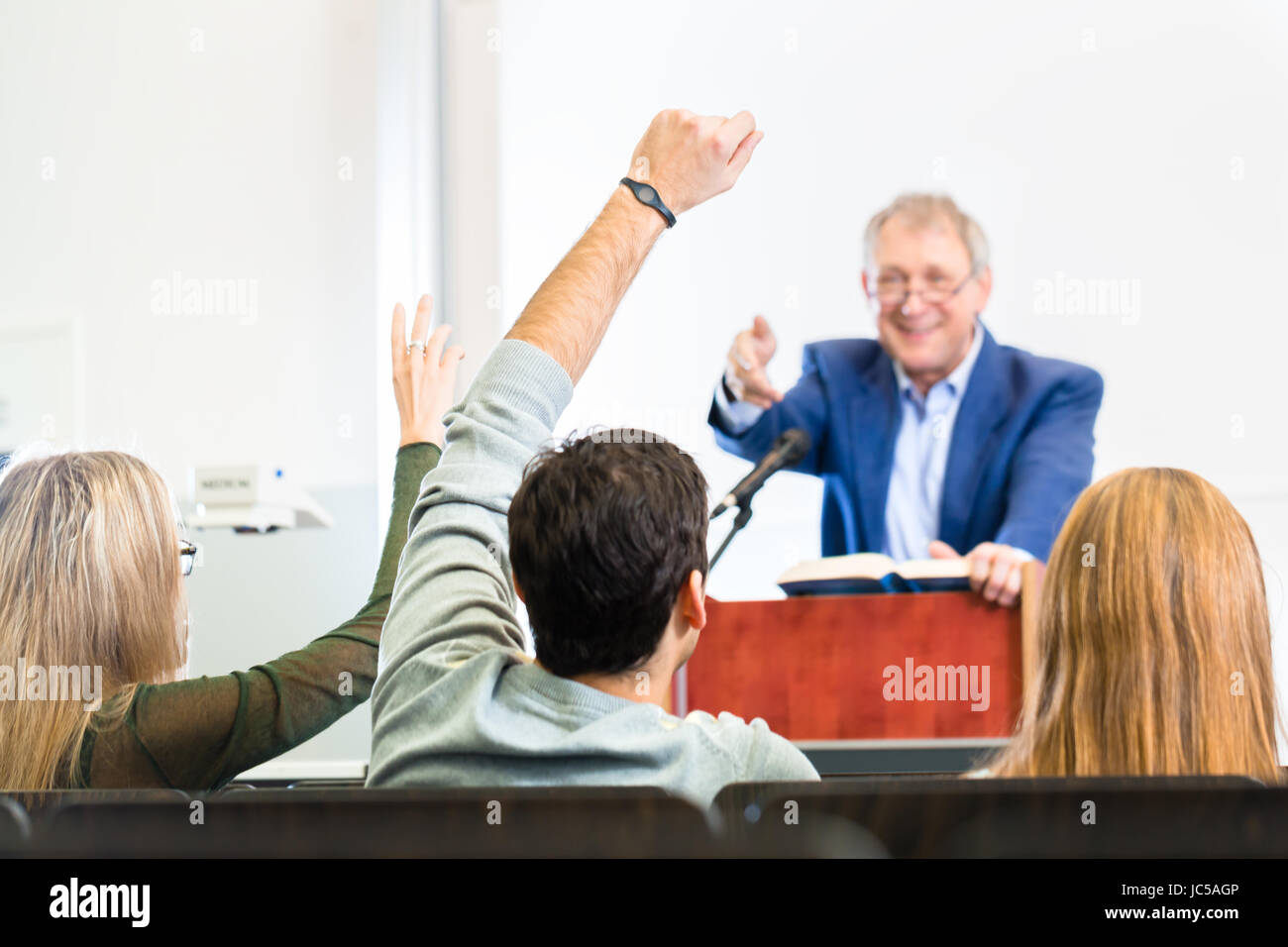 Students listening to college professor giving lecture Stock Photo - Alamy