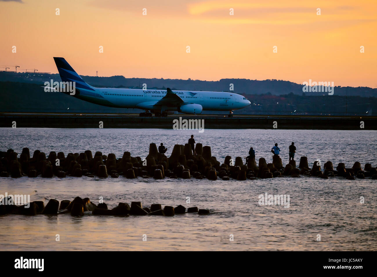 Men watching airplane on runway Stock Photo - Alamy