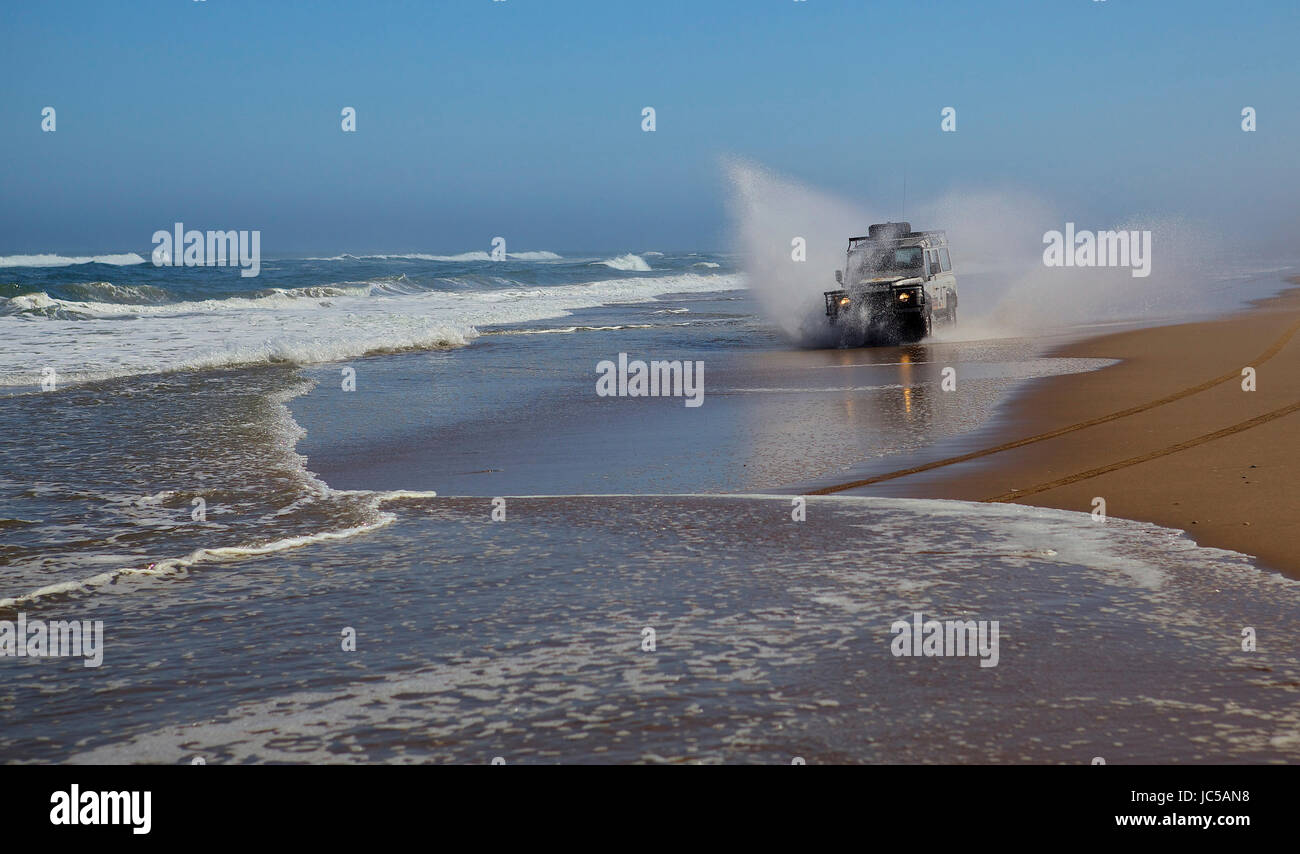 An offroad vehicle splashes through the surf Stock Photo - Alamy