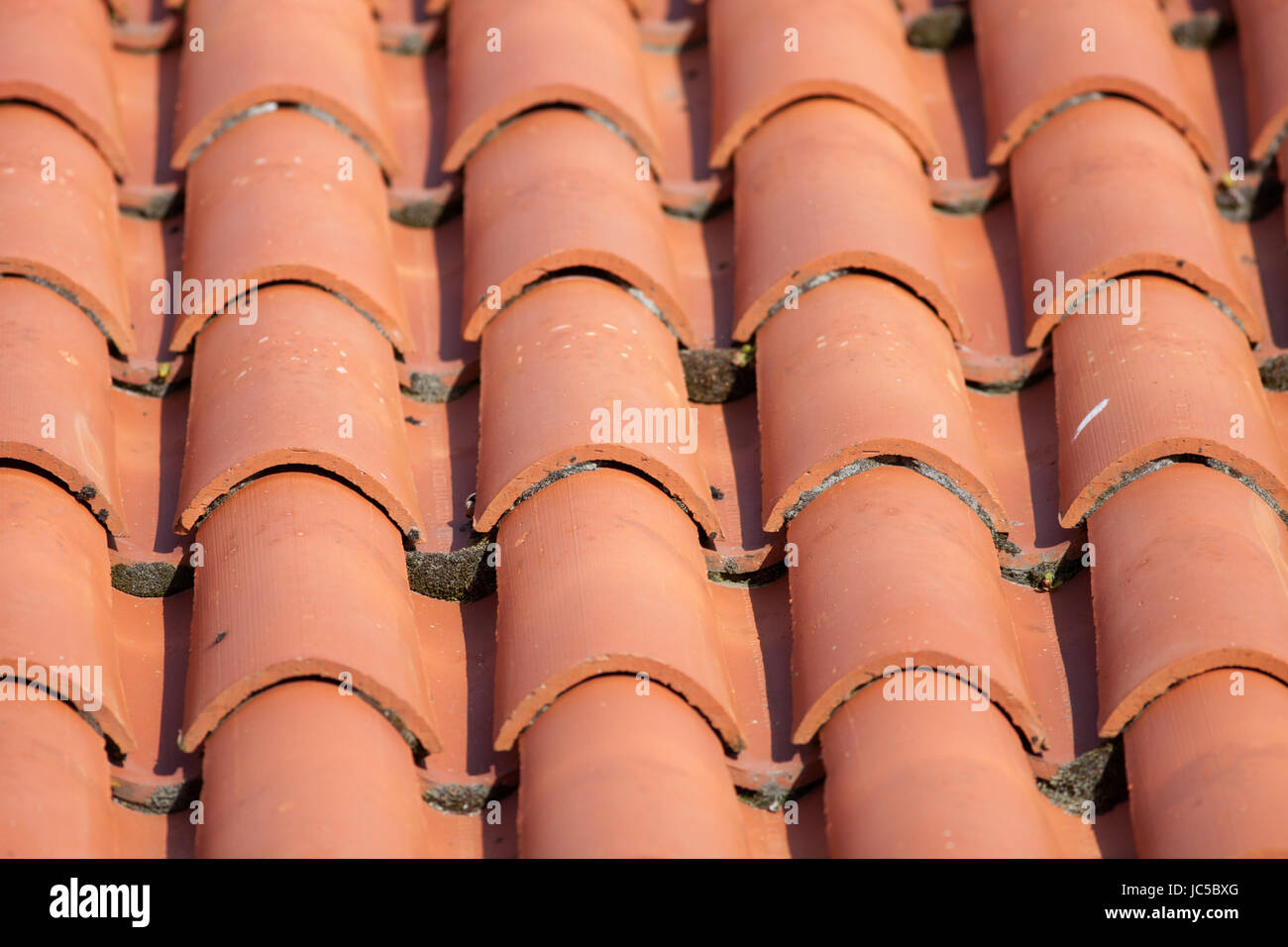 Construction detail of a red tile roof Stock Photo - Alamy