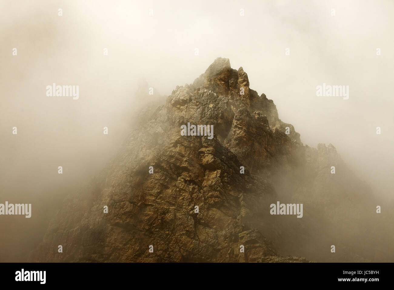 High mountain ridge in thick fog Stock Photo - Alamy
