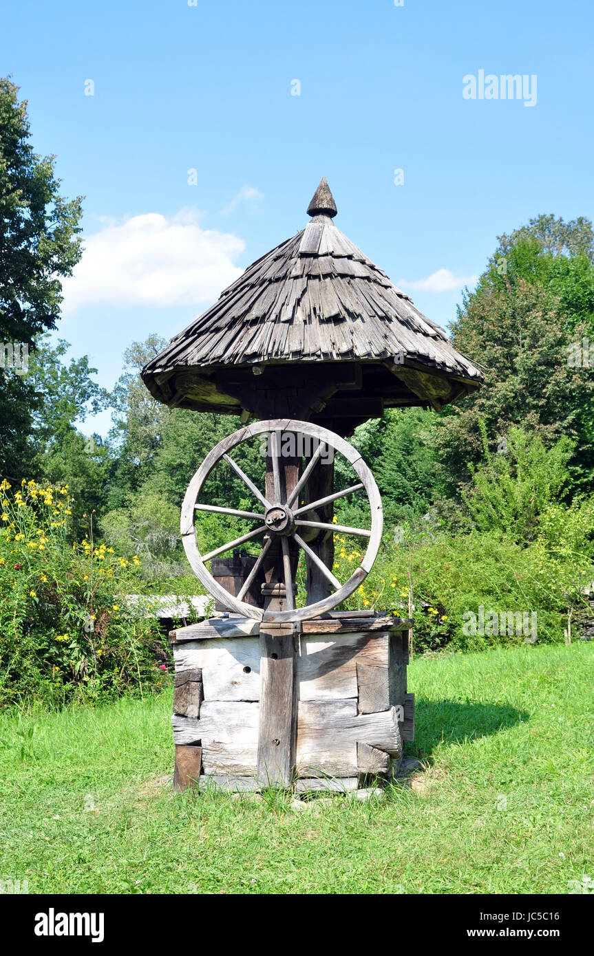 romanian medieval rustic wooden wheel water fountain Stock Photo - Alamy