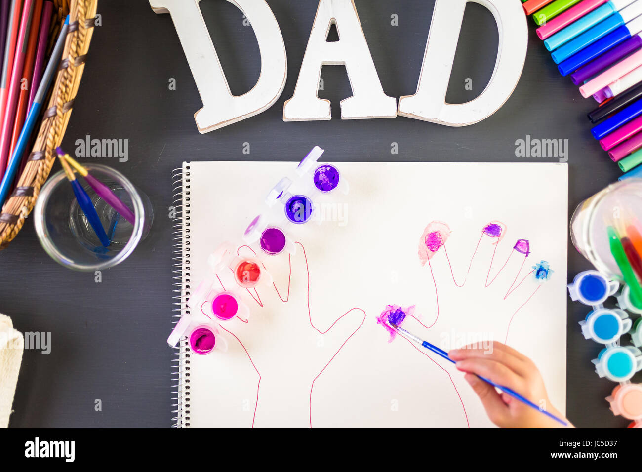 Step by step. Little girl tracing her hands for Father's Day card Stock ...