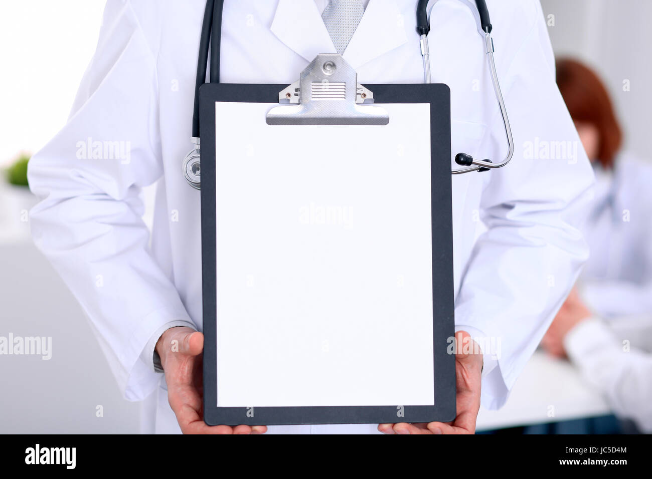 Close-up of a male doctor in a background of doctor and patient Stock ...