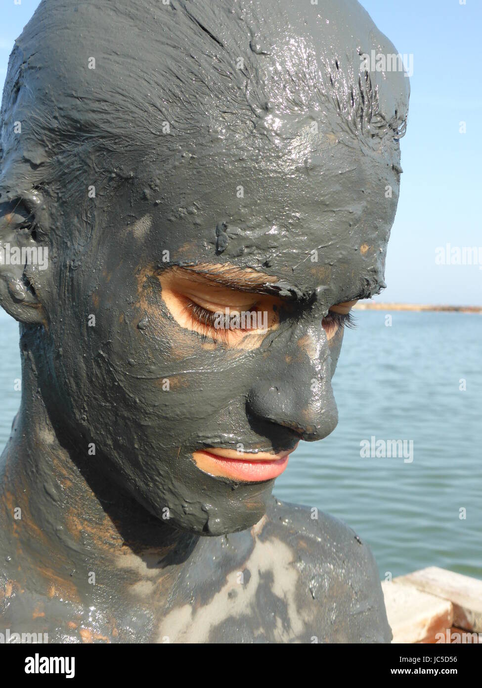 Close-up of a boy after applying a therapeutic mud bath in San Pedro ...
