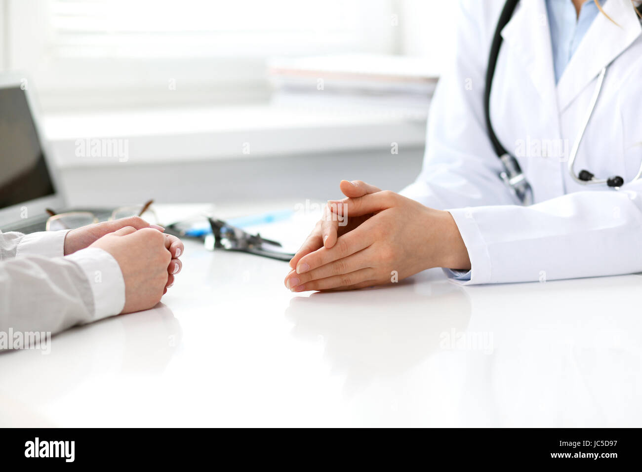 Doctor and patient sitting at the desk Stock Photo - Alamy