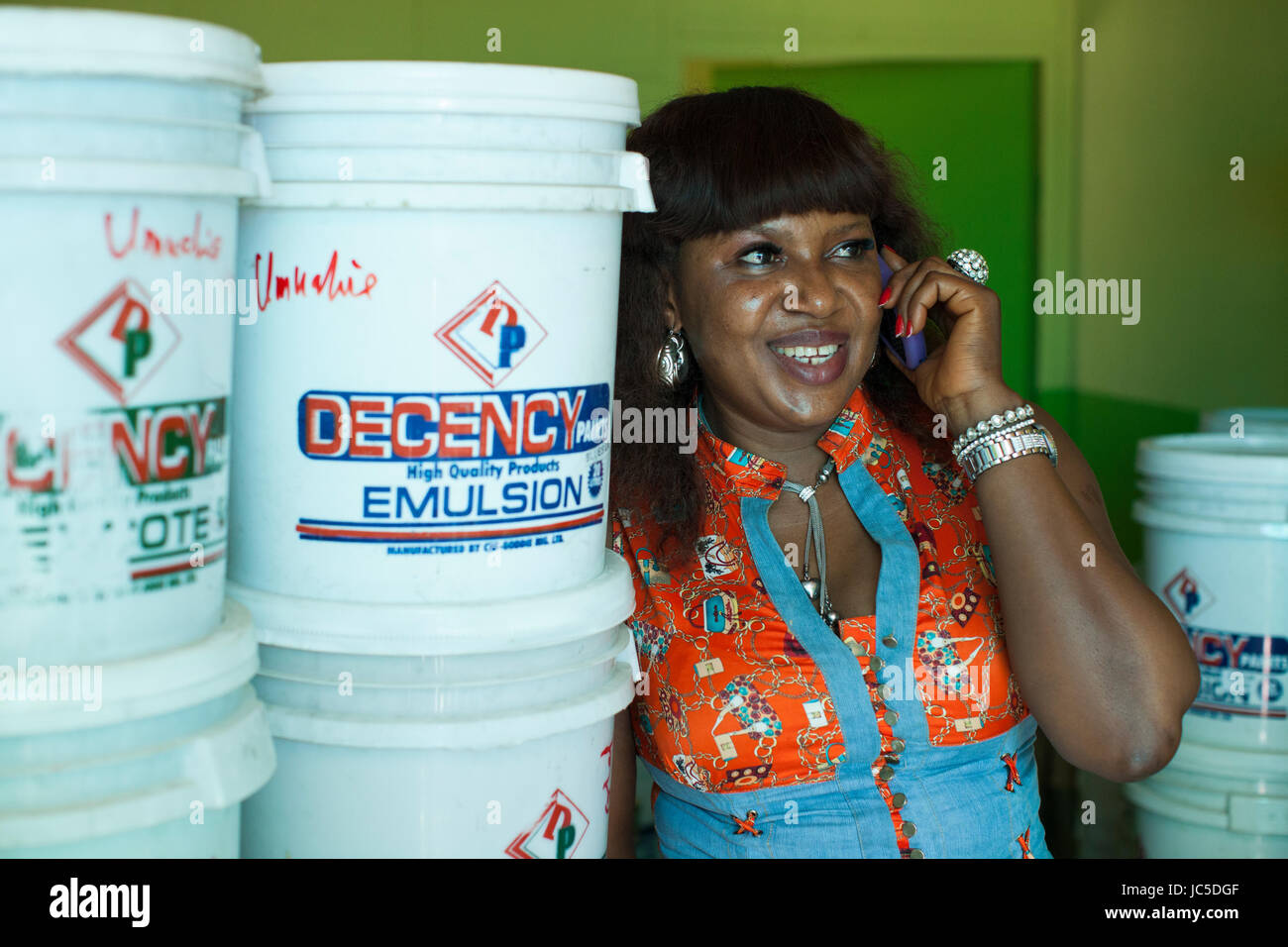 Female paint shop owner on her phone, Nigeria, Africa Stock Photo - Alamy