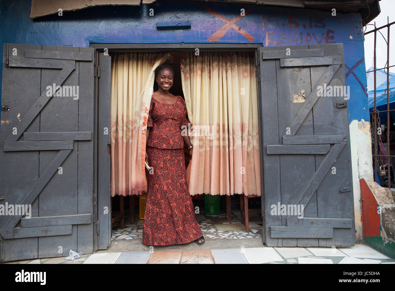 A woman standing at her shop front, Nigeria, Africa Stock Photo - Alamy