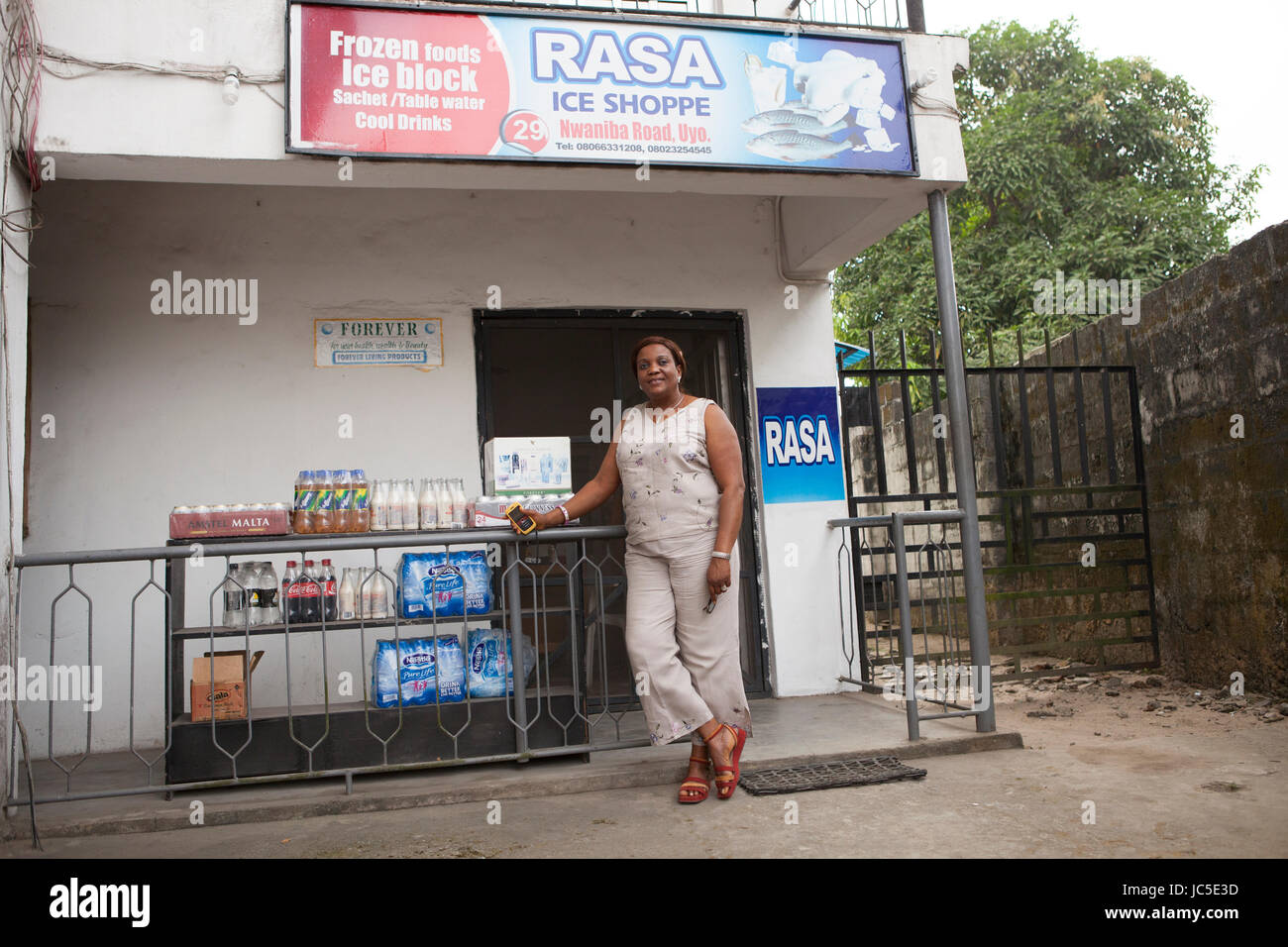 A female shop keeper outside her shop, Nigeria, Africa Stock Photo - Alamy