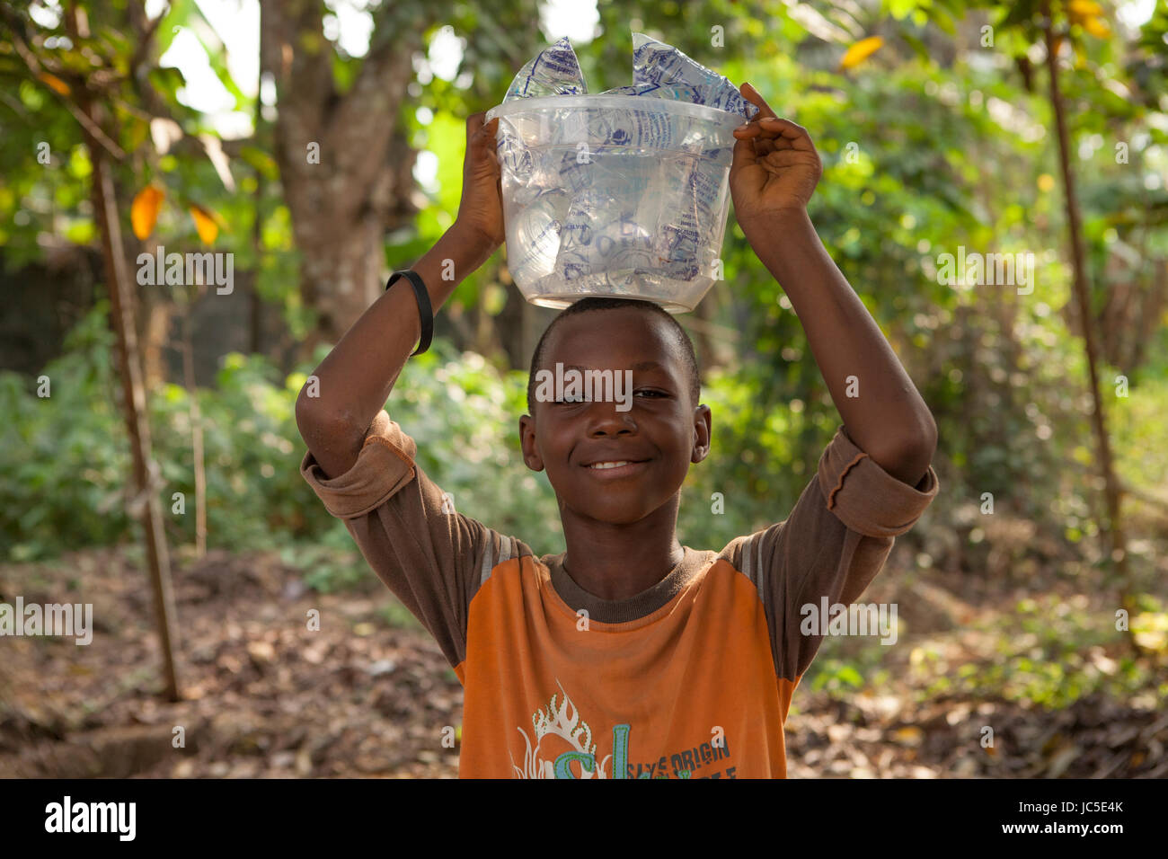 A child carrying blocks of ice on his head, Nigeria, Africa Stock Photo ...