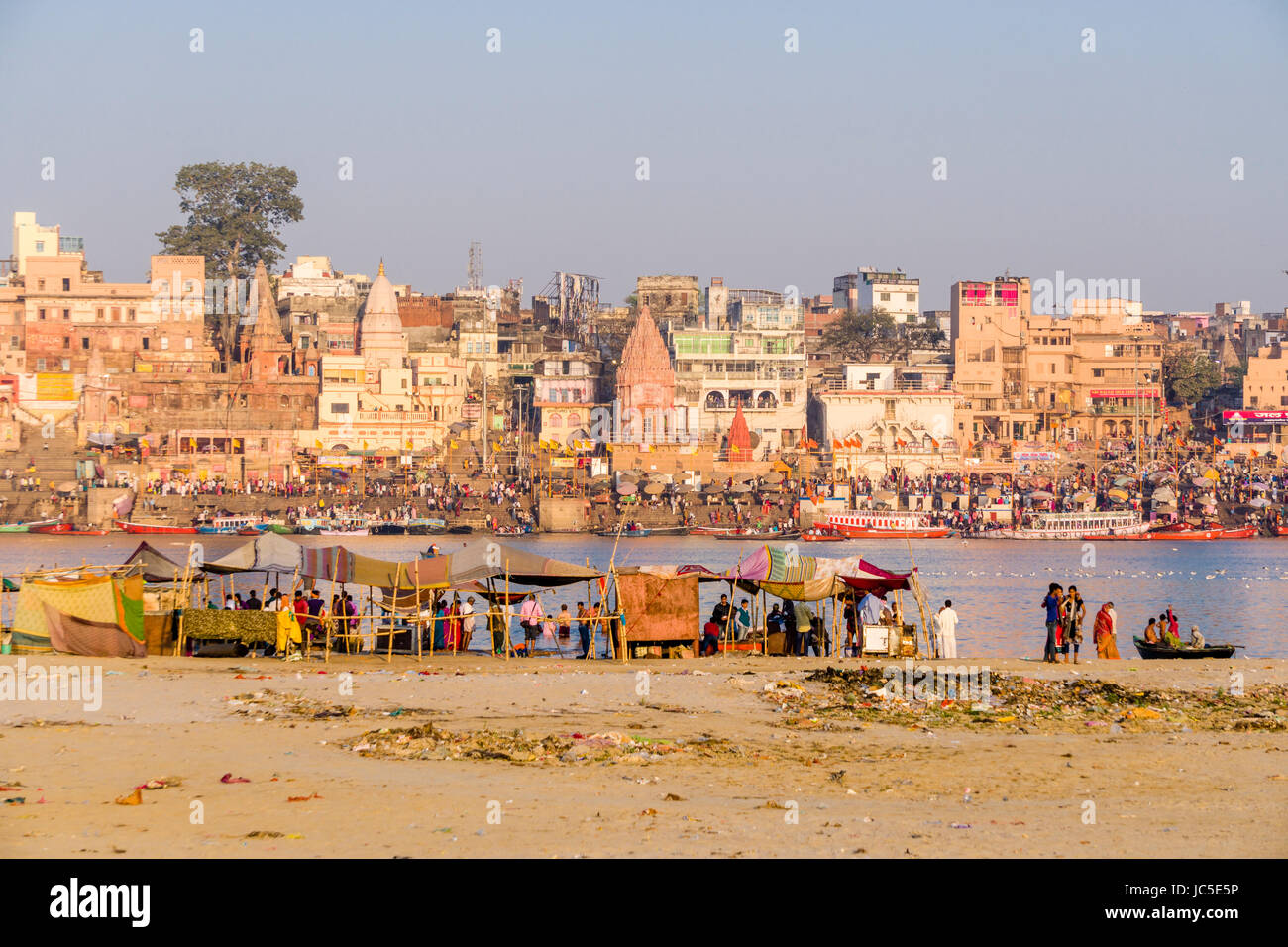 Pilgrims are gathering on the sand banks at the holy river Ganges ...