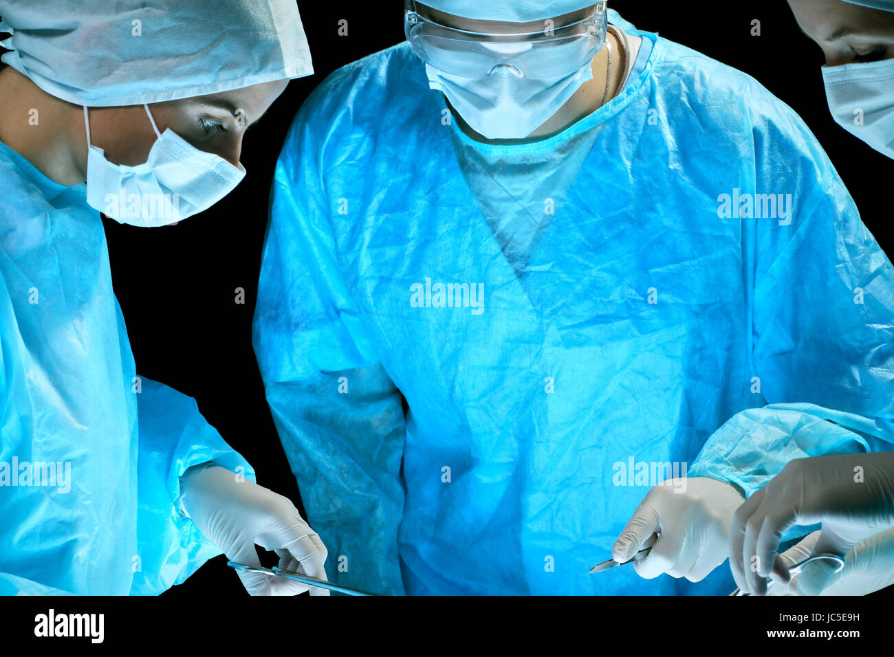 Medical team performing operation. Group of surgeon at work in ...