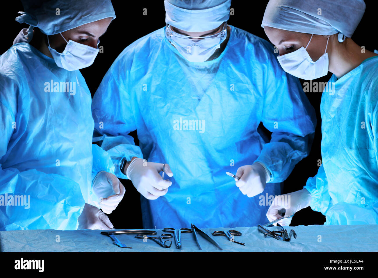Medical team performing operation. Group of surgeon at work in ...