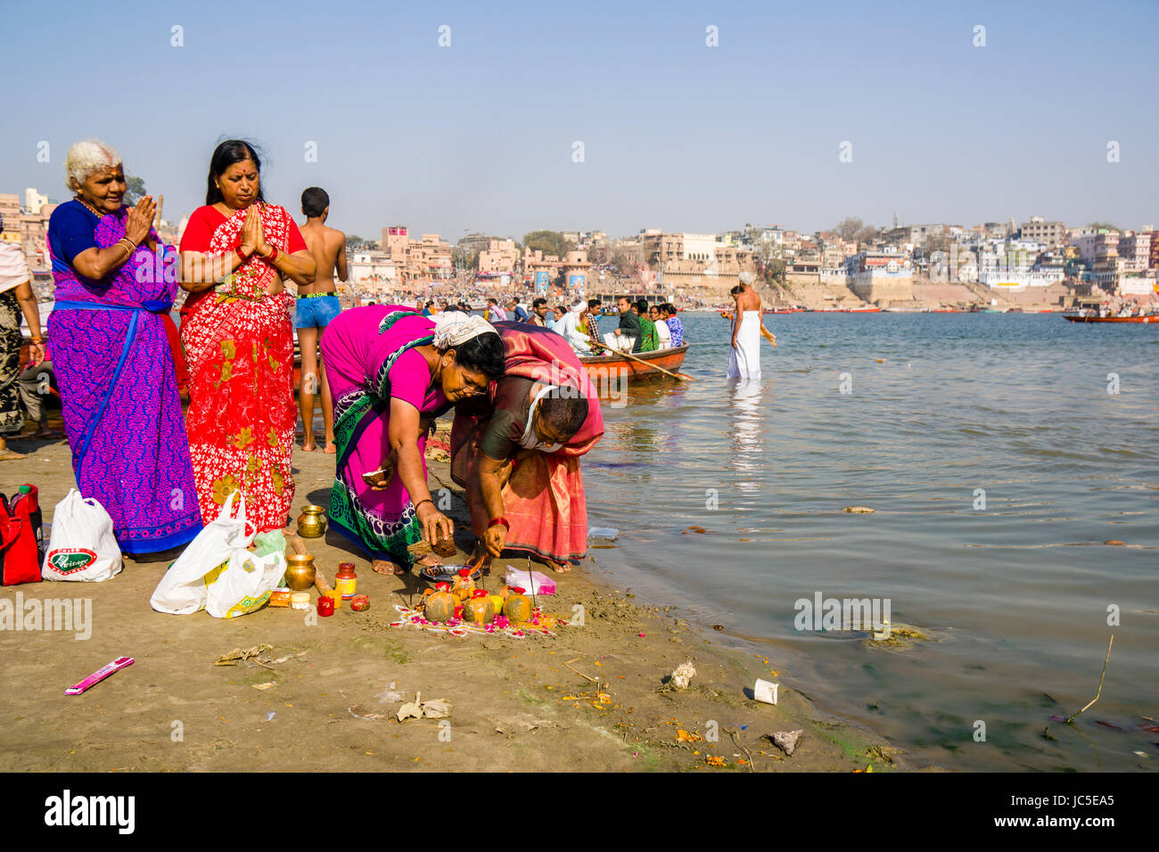 Pilgrims are performing a religious ritual on the sand banks at the ...