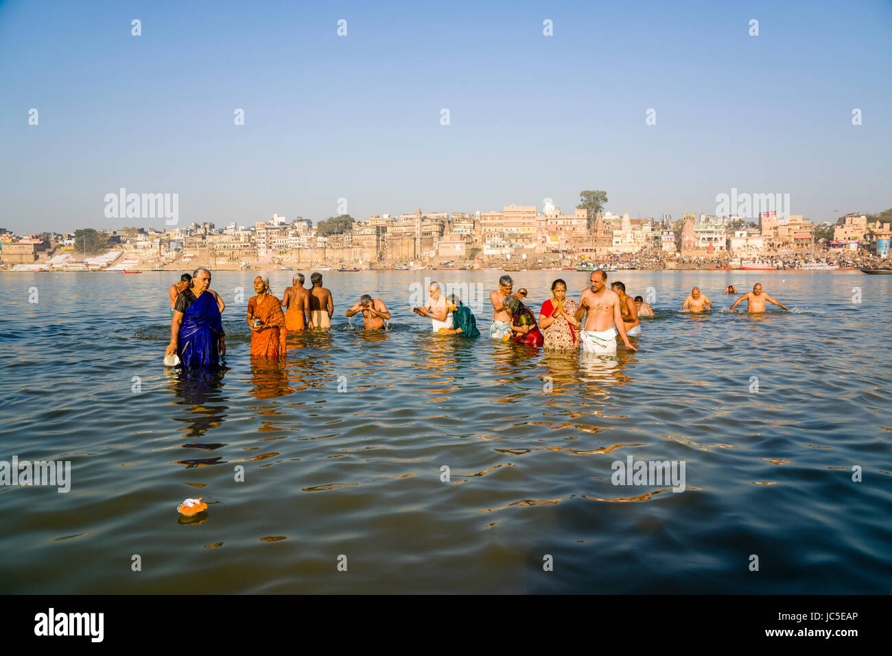 Pilgrims are taking bath and pray on the sand banks at the holy river ...