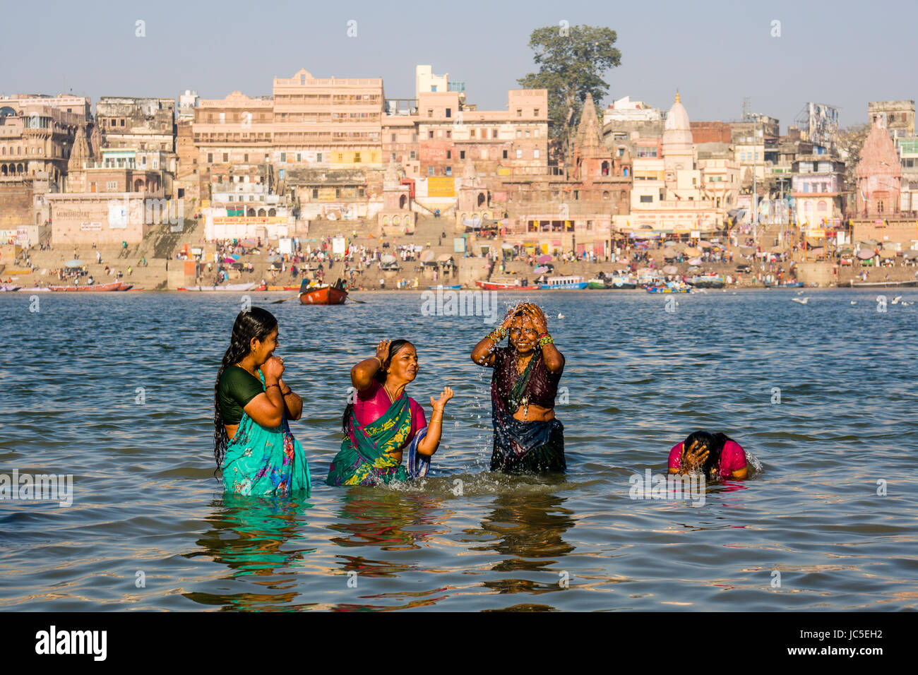 Pilgrims are taking bath and pray on the sand banks at the holy river ...