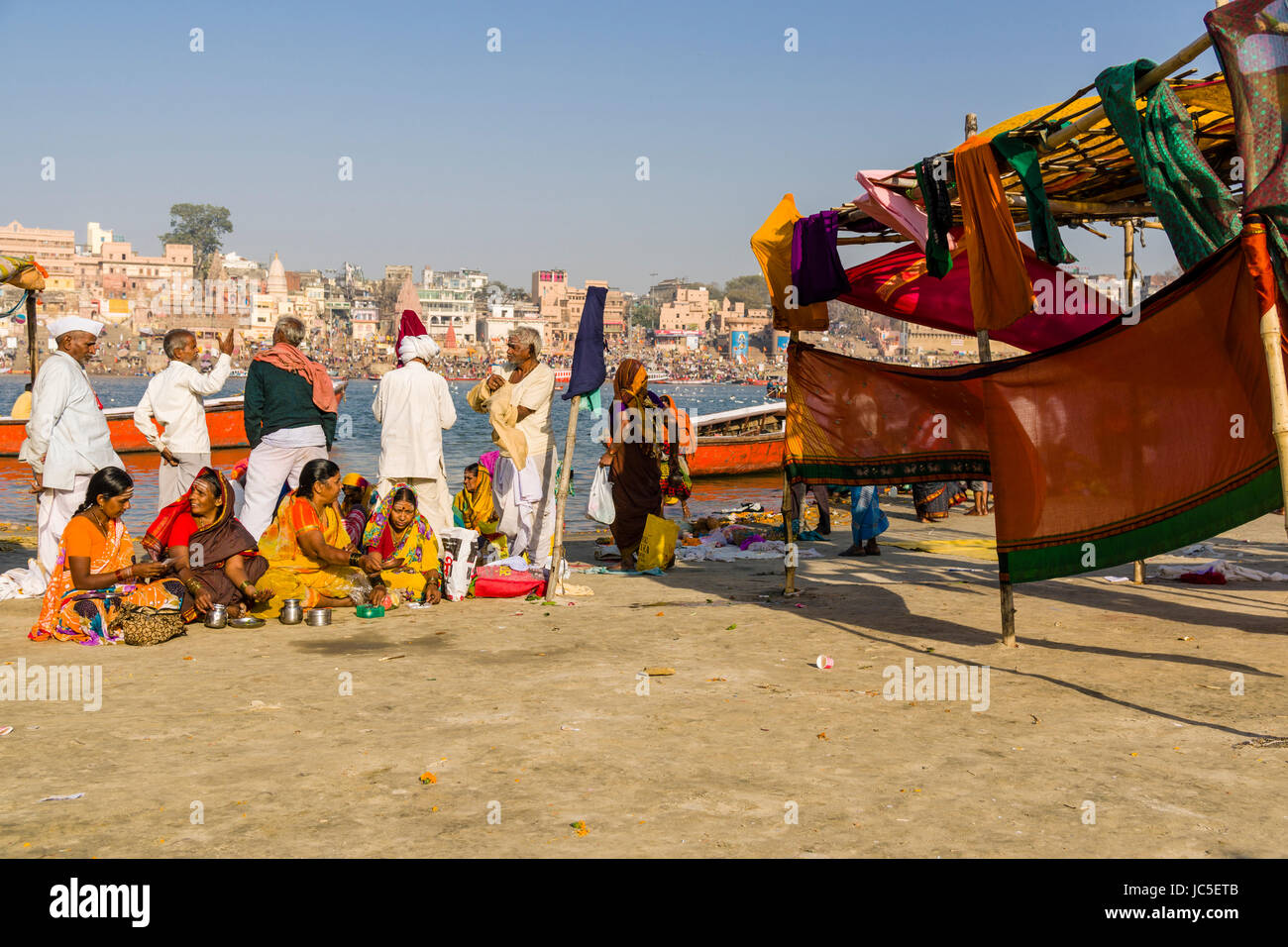 A group of female pilgrims is performing a religious ritual on the sand ...