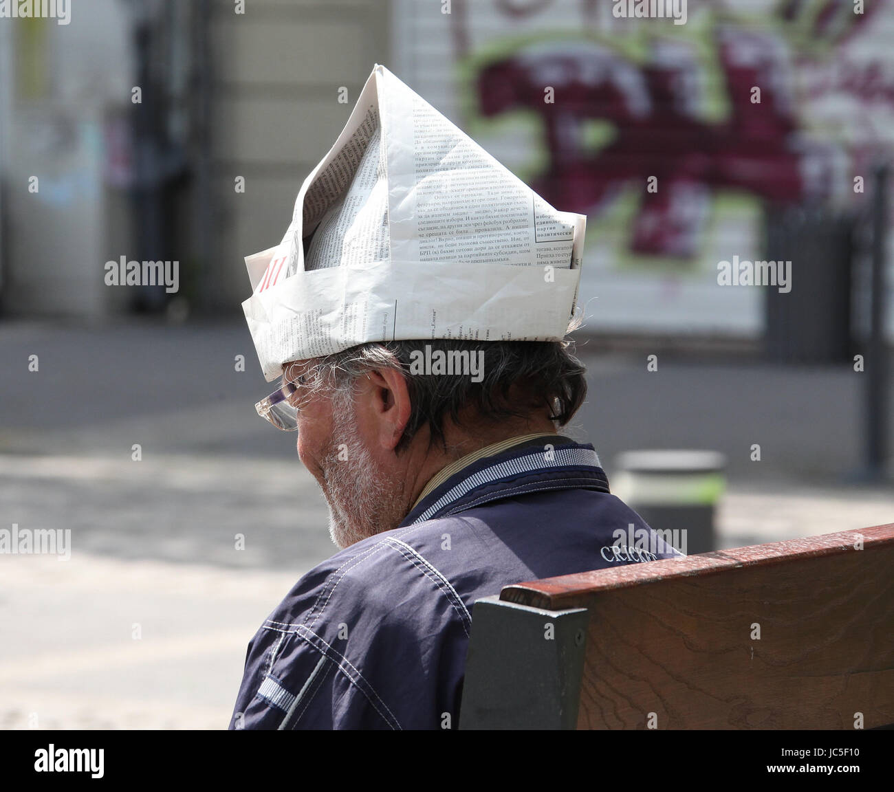 Man wearing a newspaper hat in Bulgaria Stock Photo - Alamy