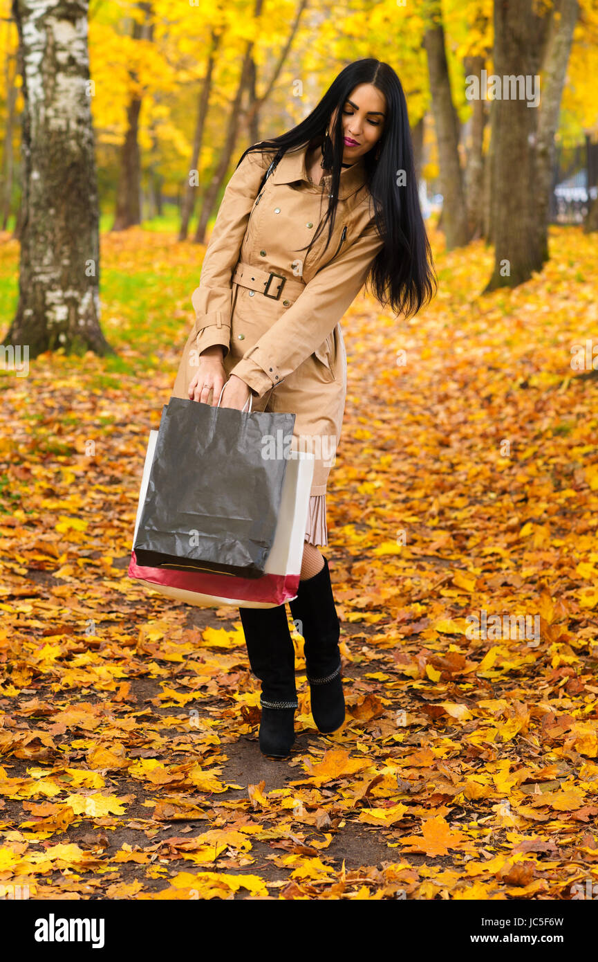 beautiful elegant woman walking in the park with shopping Stock Photo ...