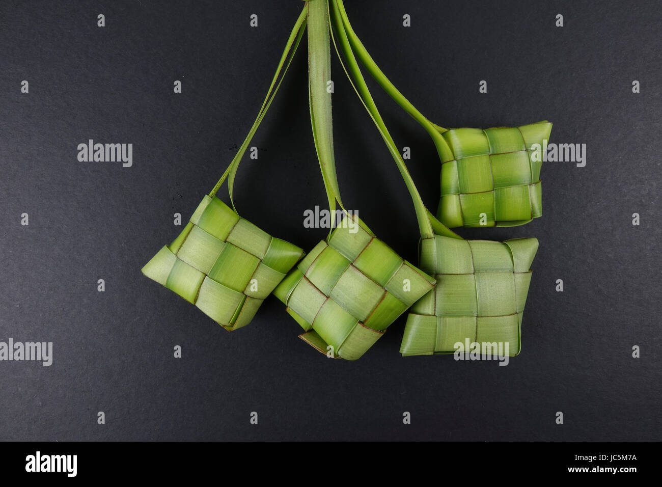 Making of Ketupat, a natural rice casing made from young coconut leaves ...