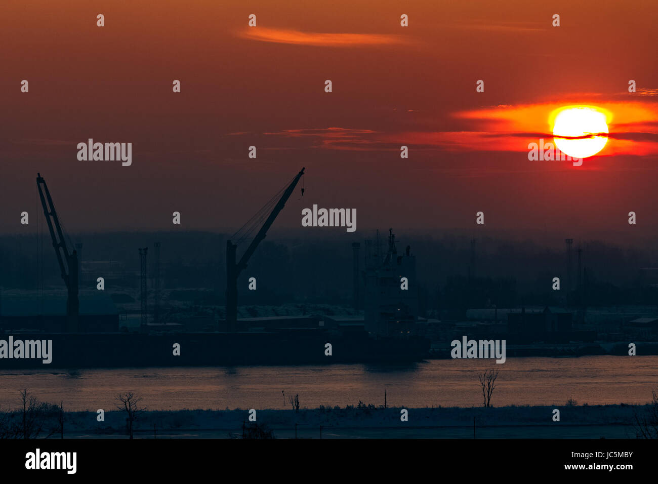 Hot orange sunset over the river. Urban landscape Stock Photo - Alamy